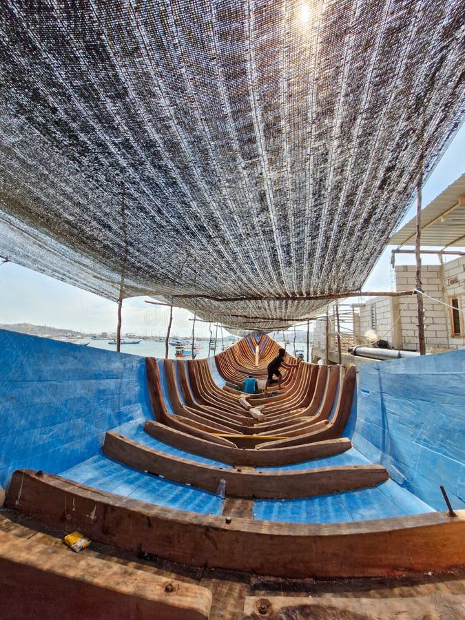 Traditional Wooden Boat Under Construction on a Beach in Indonesia ...