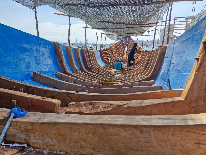Traditional Wooden Boat Under Construction on a Beach in Indonesia ...