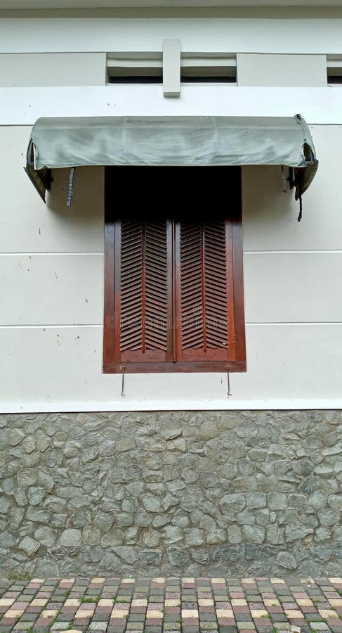 Traditional Wooden Window with Canopy on Stone and Concrete Wall Stock ...