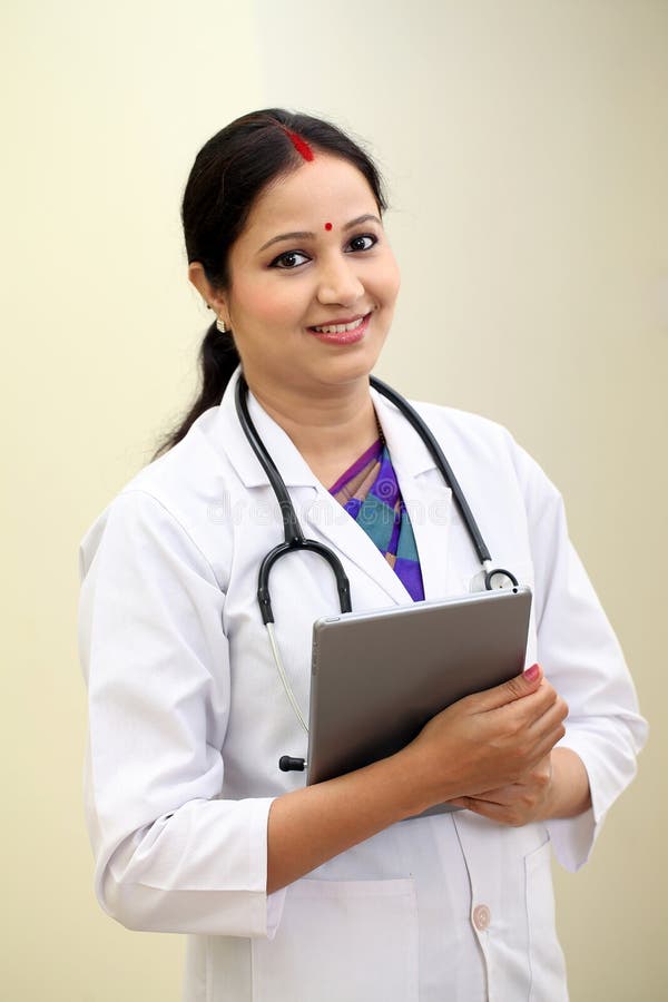 Traditional Young Female Doctor Holding Tablet Computer Stock Photo ...