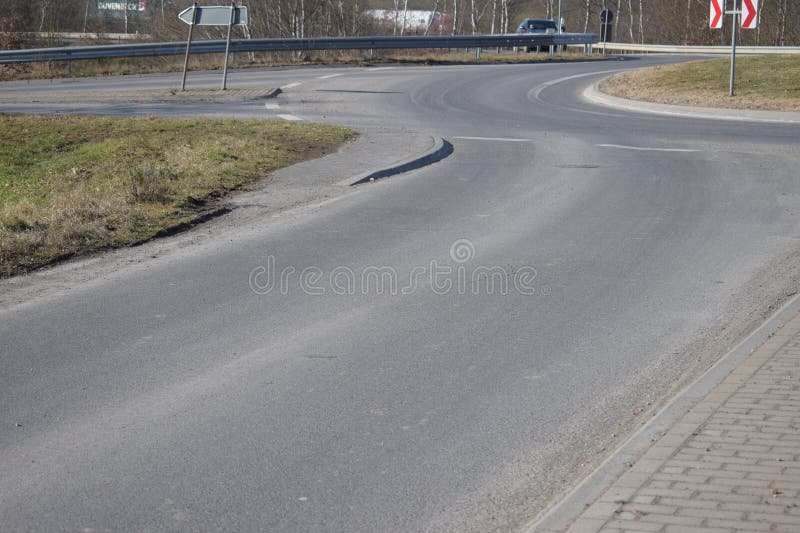 Traffic Circle Exit with a Car Behind the Barrier Stock Photo - Image ...