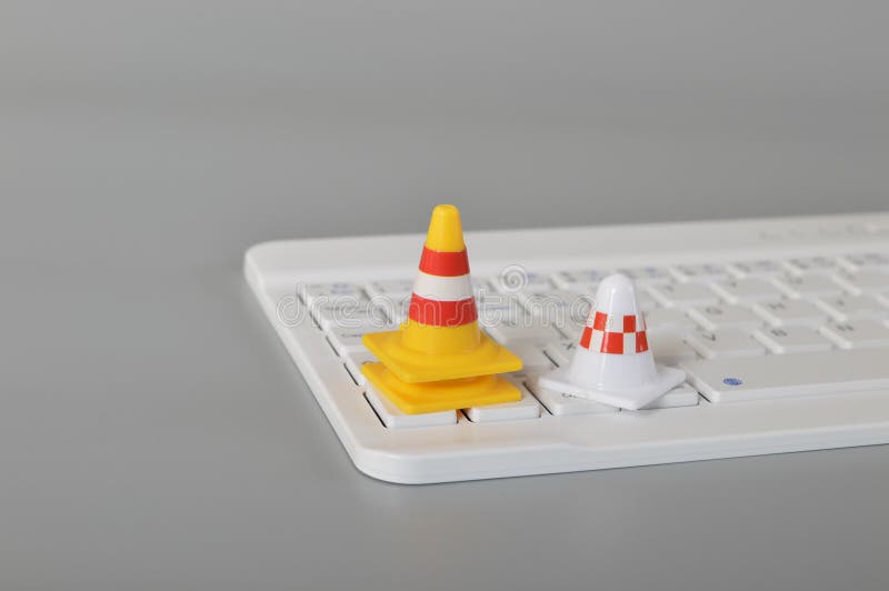 Traffic Cones and Laptop Keyboard.Computer System Under Construction ...