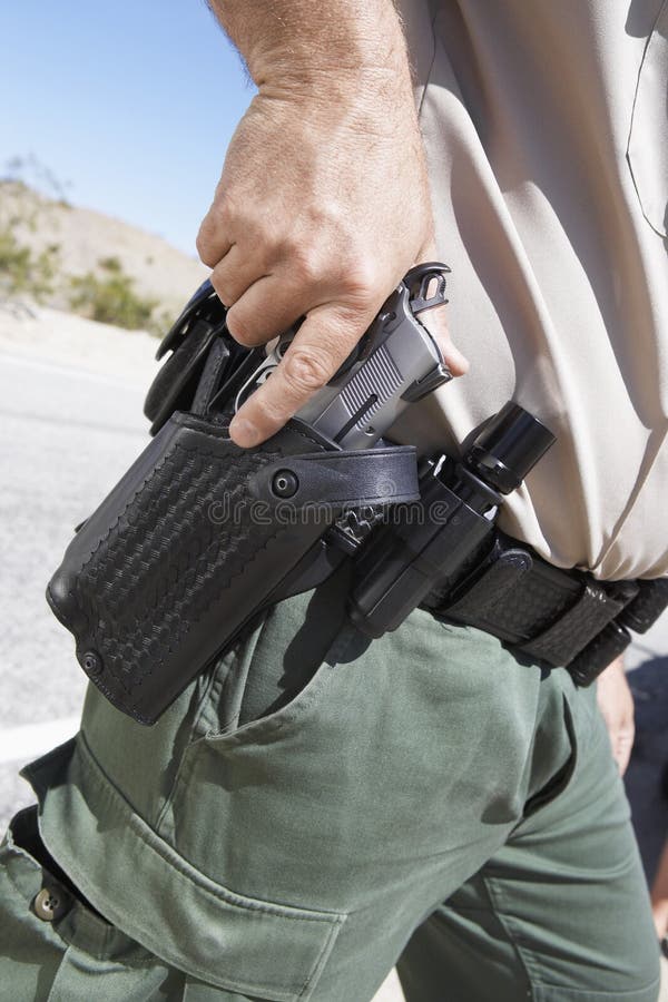 Traffic Cop Holding Gun stock image. Image of leather - 29651179 Traffic Cop Holding Gun stock image. Image of leather - 29651179