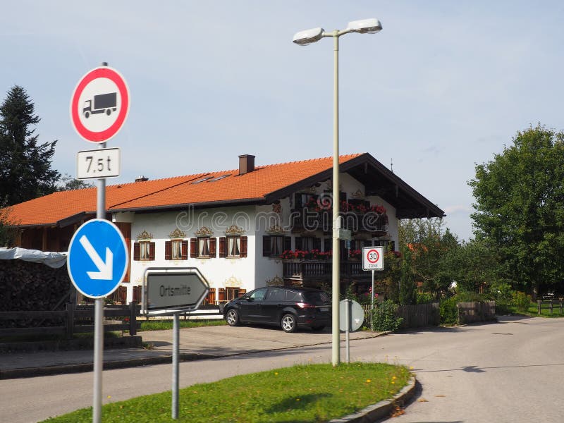 Traffic Island with Road Signs in Front of a Bavarian House Editorial ...