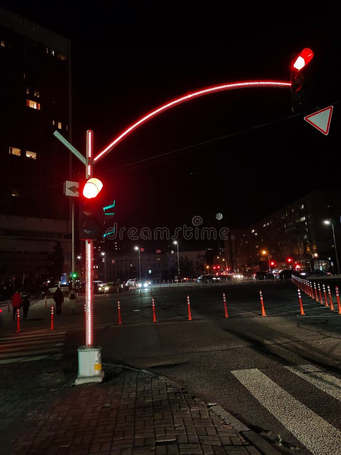 A Traffic Light Pole in the Form of an Arc with Red Lights Above the ...