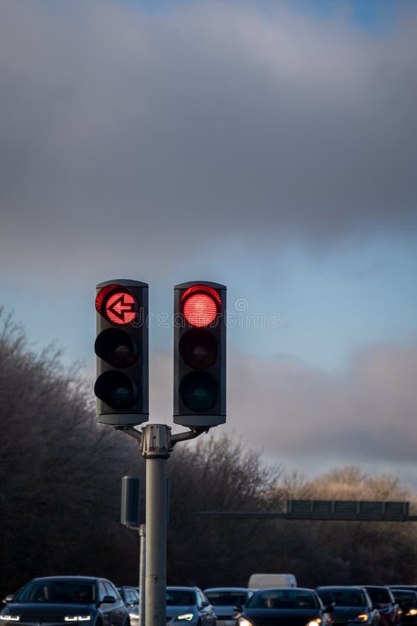 Traffic Light Showing Red Lights and Left Arrow with Traffic Behind ...