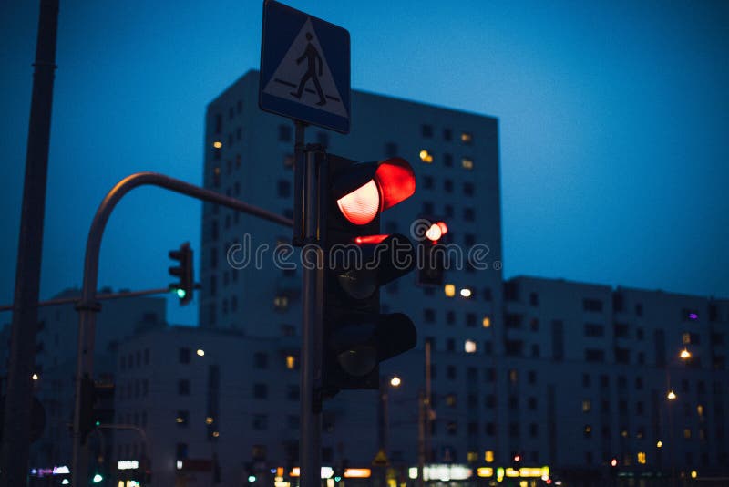 Traffic Light and Street Sign with Tall Building in the Background ...
