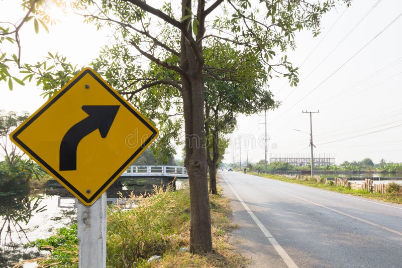 A Traffic Sign Shows a Curved Path beside the Road. on the Edge of the ...