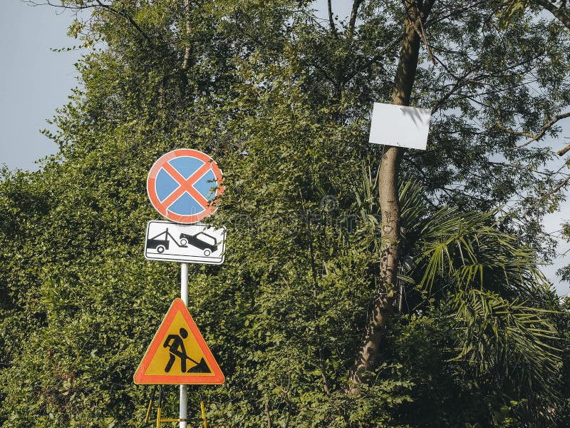 Traffic Signs on the Side of an Uninterrupted Road with Trees Along it ...