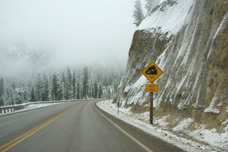 Traffic Signs on Icy Mountain Road Stock Photo - Image of curve, storm ...