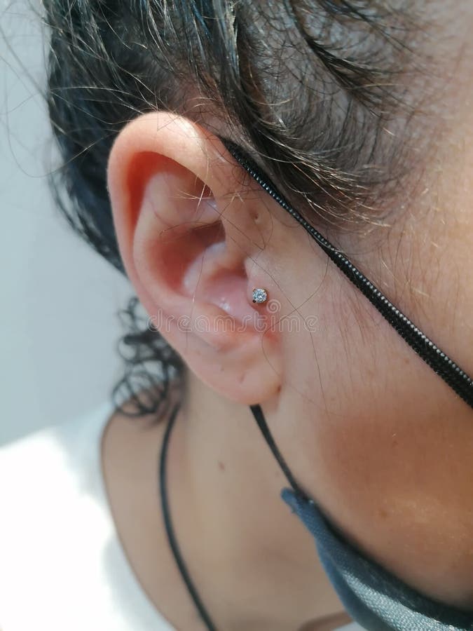 Tragus Piercing with a Titanium Labret Stock Photo - Image of pretty ...