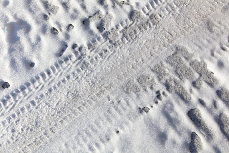 The Trail of the Car on the Paving Slabs in the Snow in Winter. Stock ...