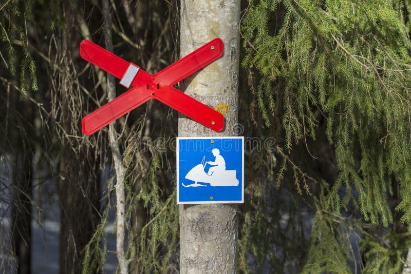 Trail Crossing Sign and a Snowmobile Sign on a Tree Trunk Stock Photo ...