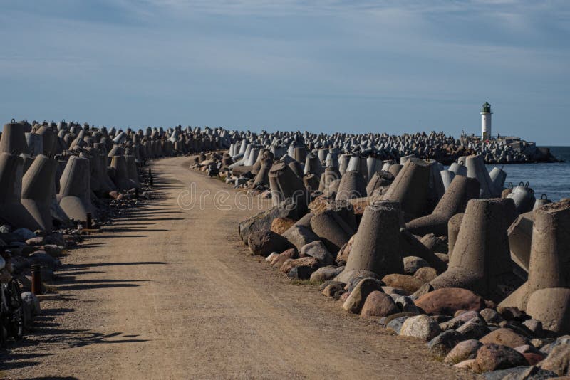 Trail Leading To a Lighthouse with Wave Breakers on the Side during the ...