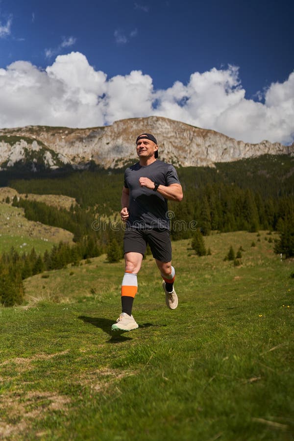 Trail runner man in a race stock photo. Image of mature - 317324666