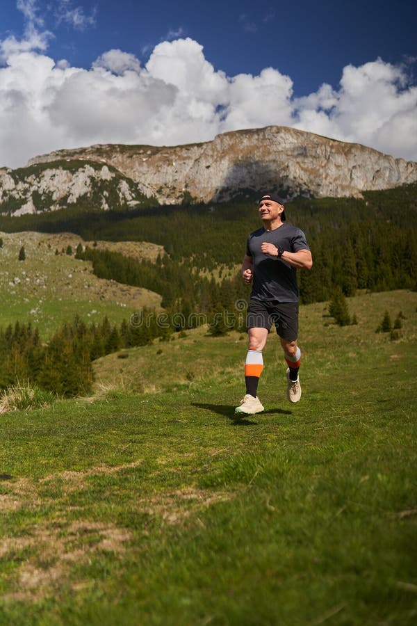 Trail runner man in a race stock image. Image of mature - 317324675