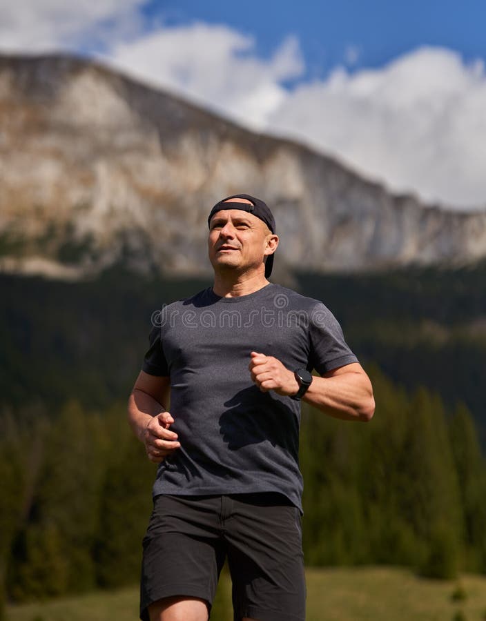 Trail runner man in a race stock photo. Image of pasture - 317324734