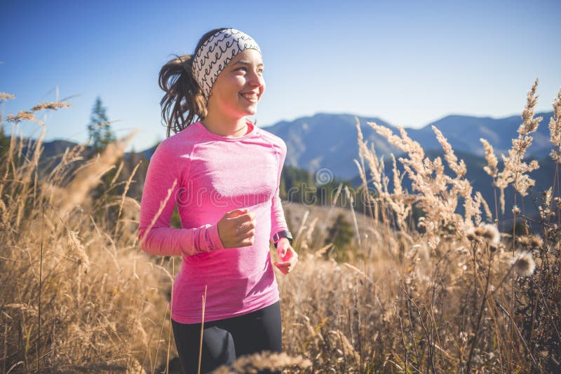 Trail Running Athlete Exercising for Fitness. Young Woman Smiling ... Trail Running Athlete Exercising for Fitness. Young Woman Smiling ...
