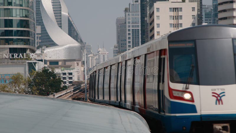 Train is Approaching on an Elevated Rail Track with Modern Buildings in ...