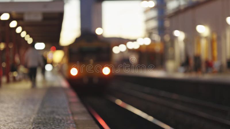 A Fast-Approaching Train on the Tracks at a Crowded Station Stock Video ...