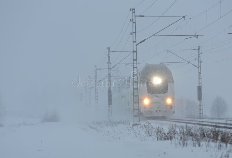 A Train Coming through a Heavy Snowstorm in the Winter Time Editorial ...