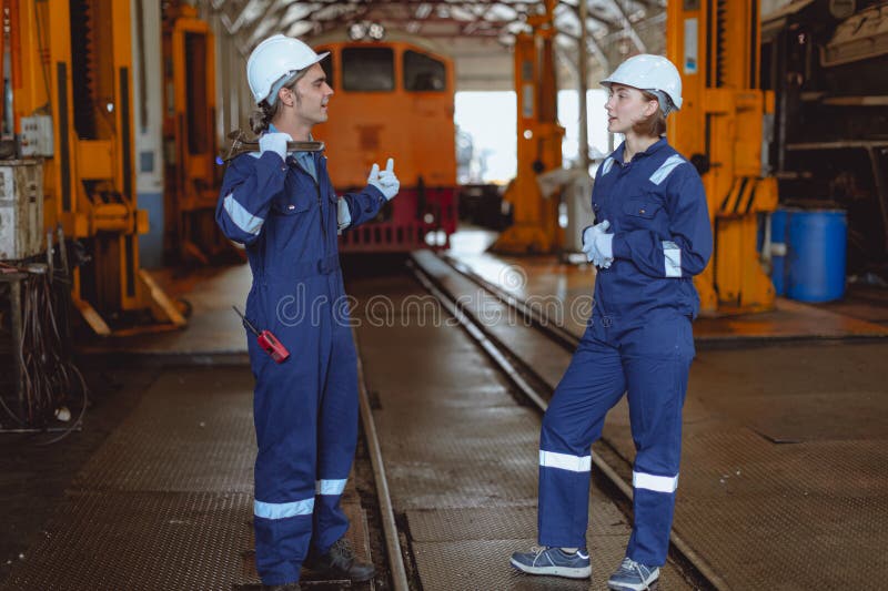 Train Engineer Team Working Together at Train Depot Service Maintenance ...
