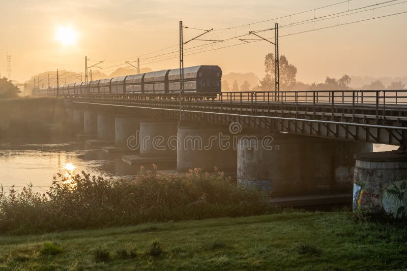 Train Going Over a Bridge at Sunrise Stock Photo - Image of traffic ...