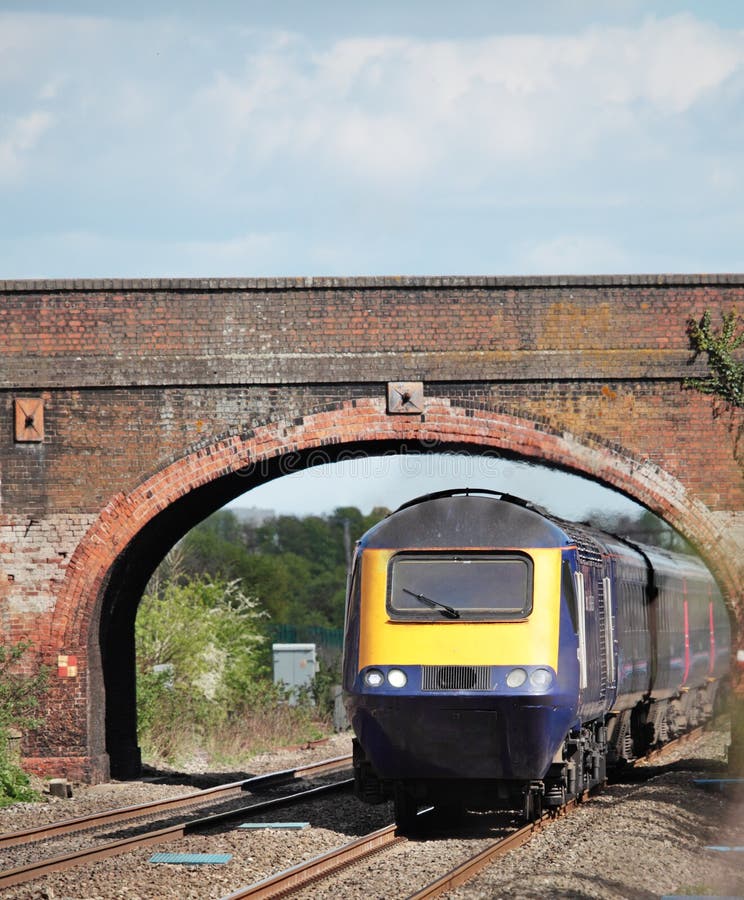 Train going under bridge stock photo. Image of bridge - 19320600
