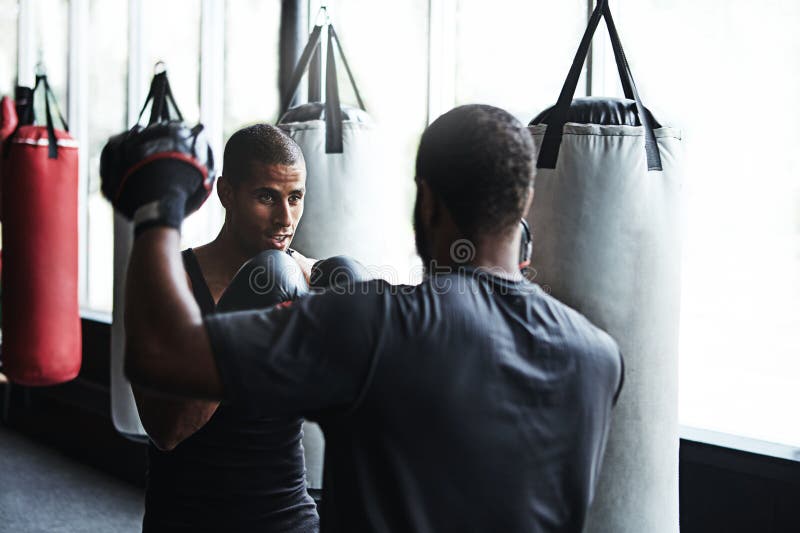 Train Hard, Fight Easy. a Male Boxer Practising His Moves with His ...