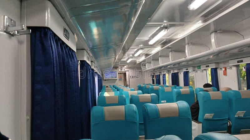 Train Interior Featuring Rows of Cushioned Seats Upholstered in ...