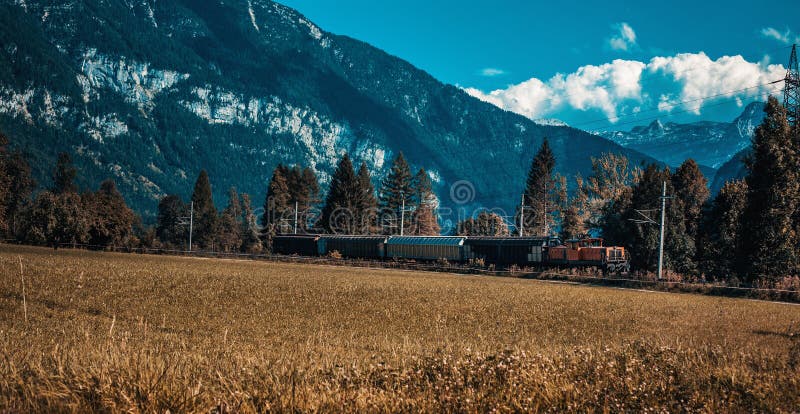 Train Locomotive with Freight on Mountains Background Stock Image ...