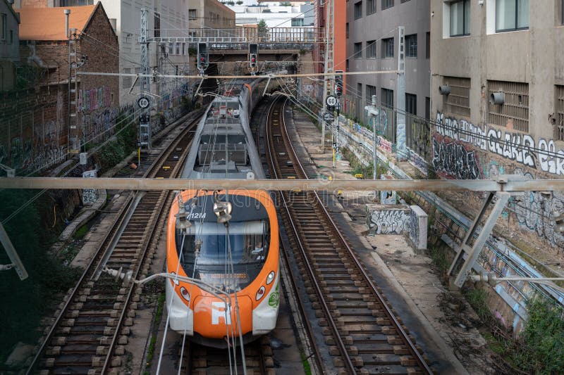 Train Passing through the City between Buildings Seen from the Bridge ...
