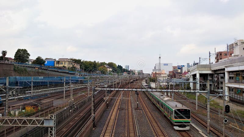 A Train Passing through a Station with Empty Track Alongside Under a ...