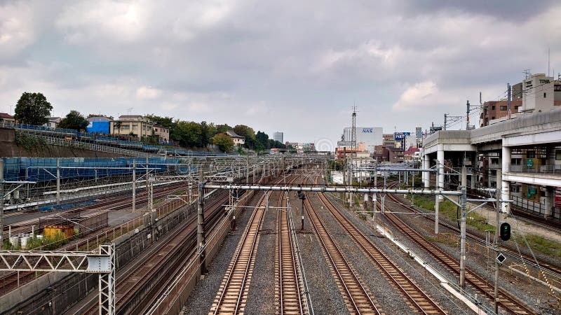 A Train Passing through a Station with Empty Track Alongside Under a ...