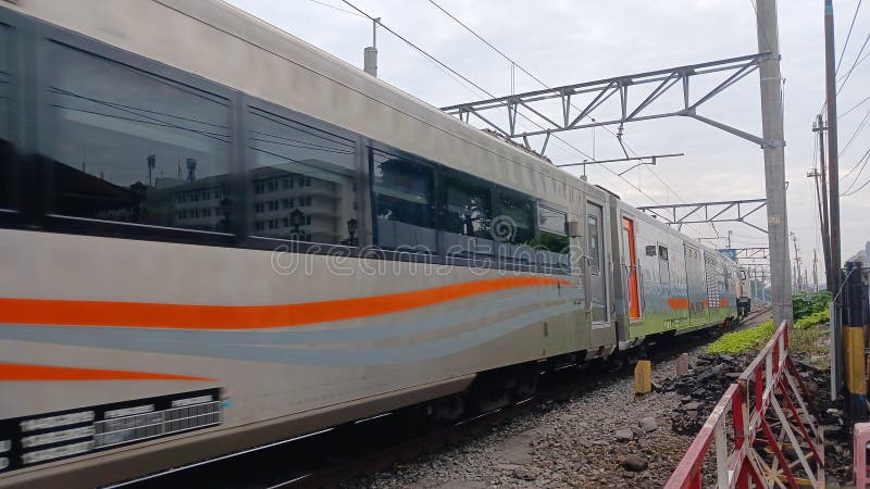 The Train is Predominantly Gray with Orange and Blue Stripes. Editorial ...
