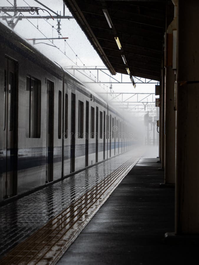 A Train Pulling into a Station in Heavy Rain Stock Image - Image of ...
