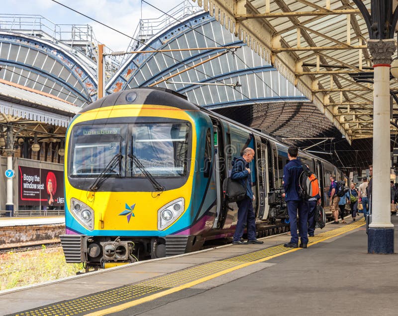 A Train Pulls into a Railway Station Platform Under Two Arches. Crew are Talking Editorial Stock ...