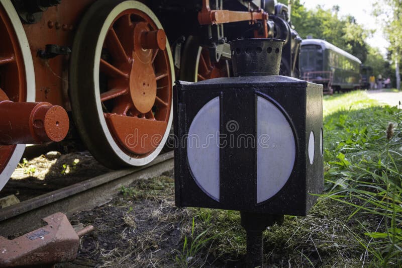 A Train with a Red and Black Wheel and a Black and White Box on the ...