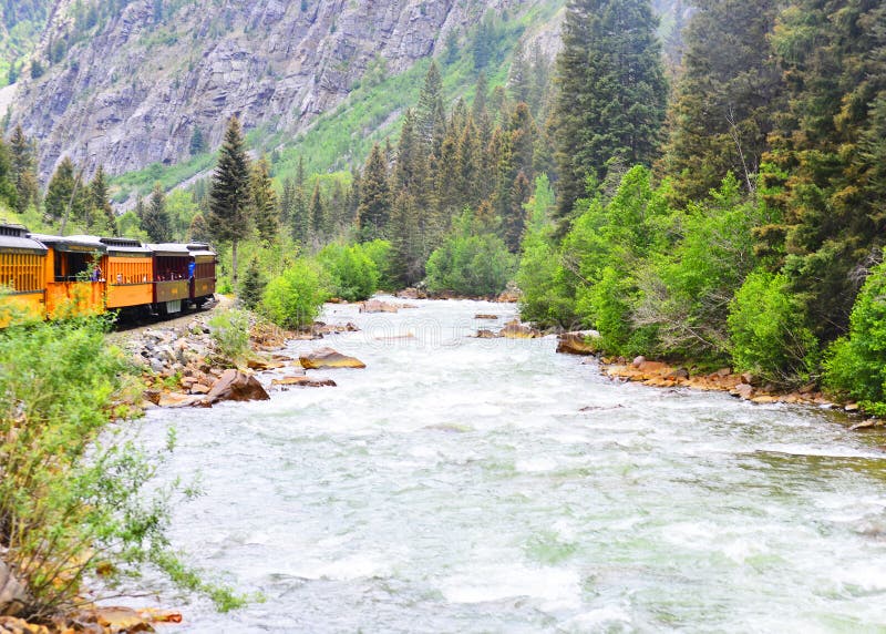Train Running Along a River through the Mountains. Stock Photo - Image ...