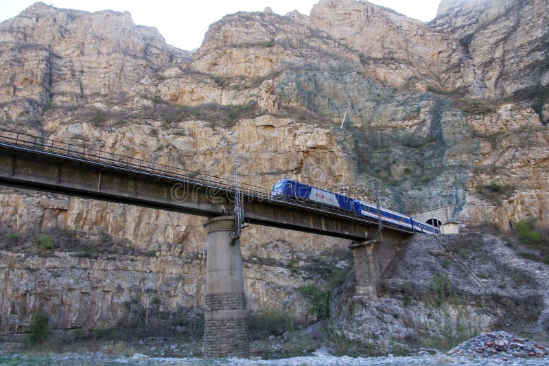 The Train Runs on the Tracks on the Viaduct in the Mountain Stock Photo ...