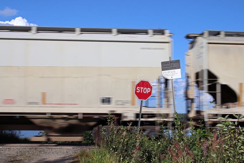 A Train Speeds Past a Stop Sign at a Crossing Stock Image - Image of ...