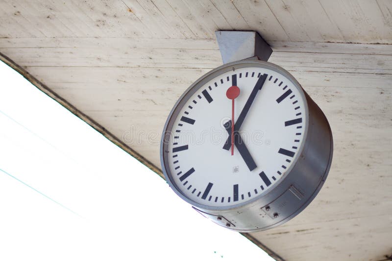 Train Station Clock on the Platform with Railroad Tracks in the ...
