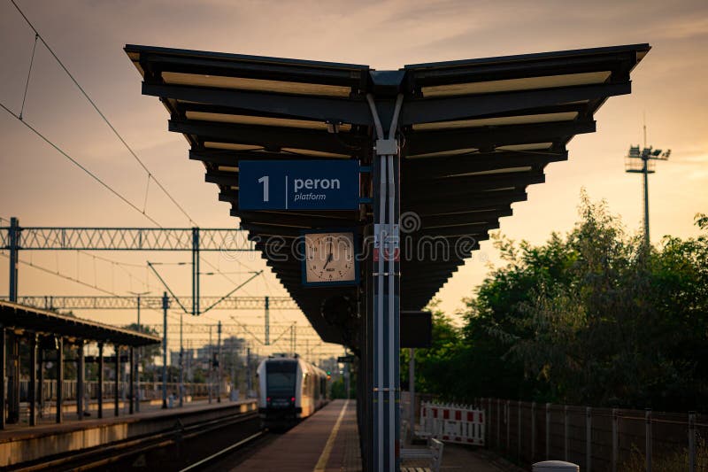 A Train at a Train Station Platform with a Bench Under it Editorial ...
