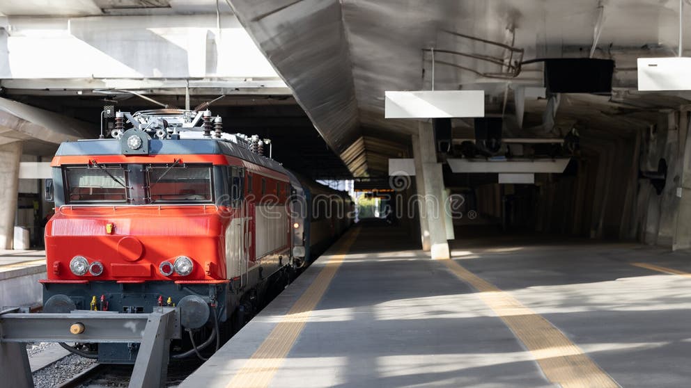 A Train Station with Various Levels and a Red Train. Stock Image ...
