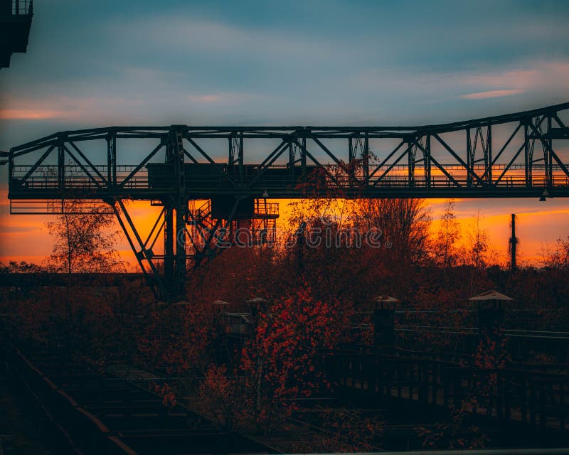A Train Track Bridge that is Over the Train Tracks in the Sunset Stock ...