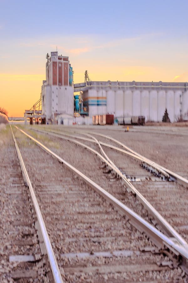 A Train Track with a Grain Silo in the Background Stock Image - Image ...