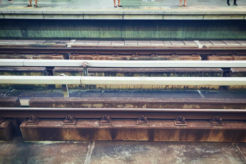 Train Track at Train Station with Office Worker`s Legs Background Stock ...