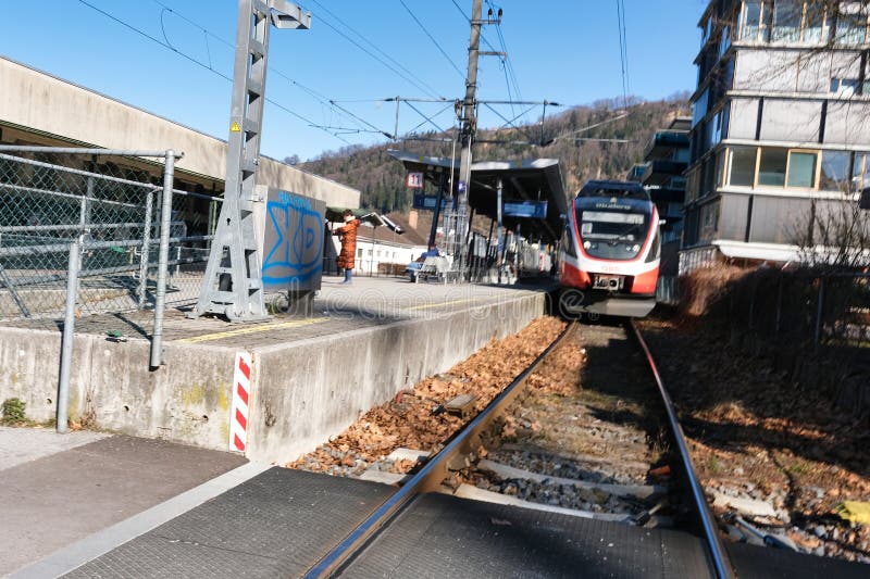 An Oncoming Train is on the Tracks in Front of a Building Editorial ...