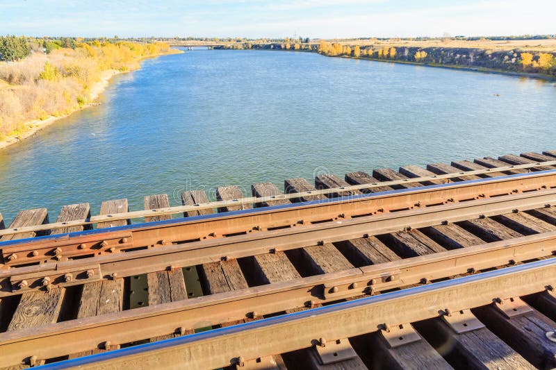 The Train Tracks are Old and Rusty, and the Water is Calm Stock Image ...