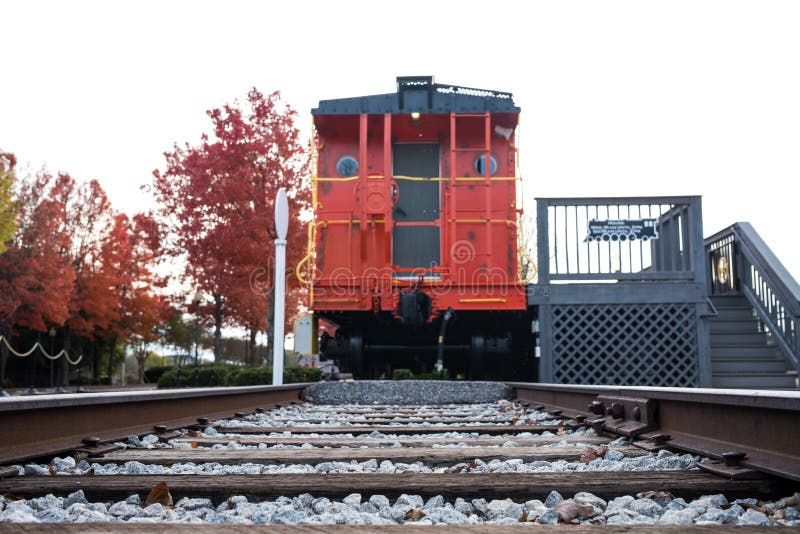 Train Tracks and Red Caboose from a Low Angle Stock Photo - Image of ...
